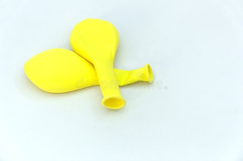 A Few Deflated Yellow Balloons on White Background Stock Image - Image ...