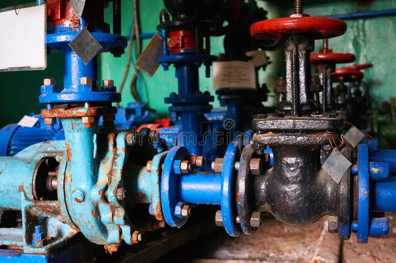 A Few Old Black Valves with Red Handles on a Cold Blue Water Pipe ...