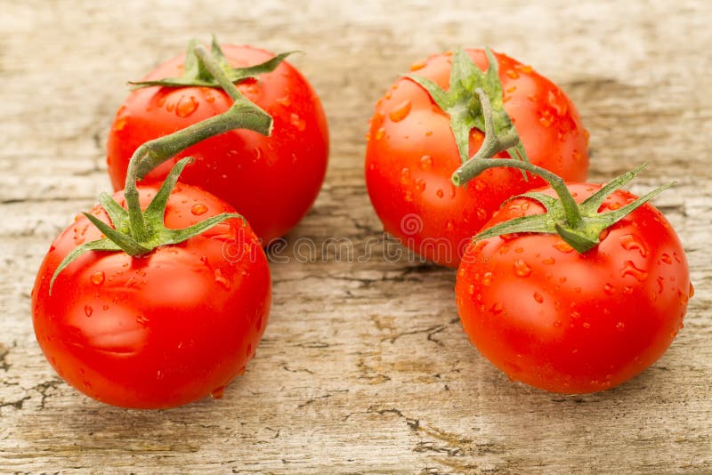 Red Tomatoes on Branch and Two Sweet Bell Peppers on Wooden Table Stock ...