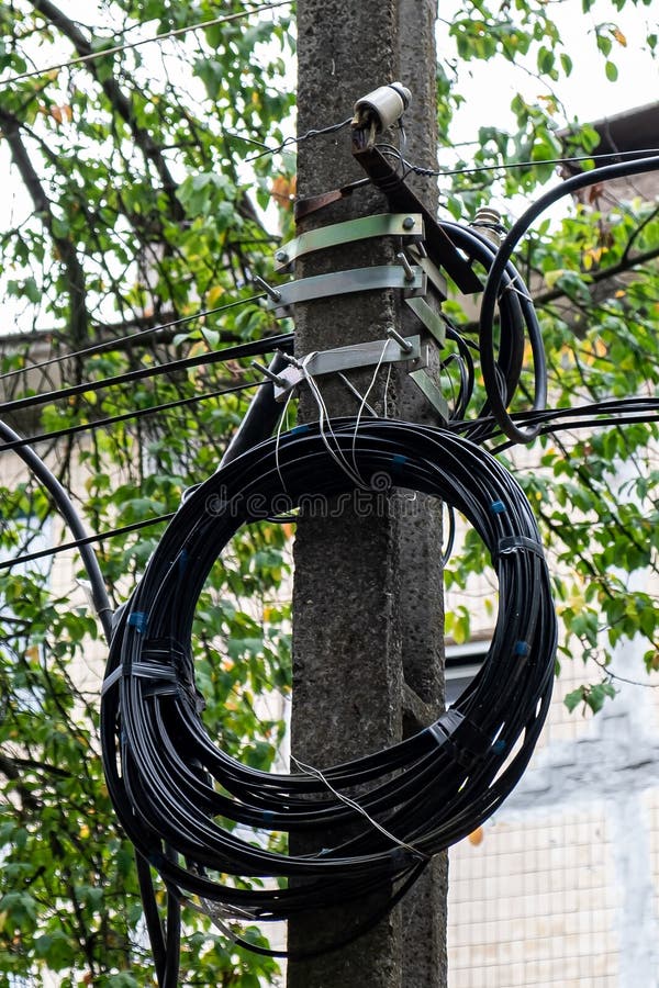 A Fiber Optic Cable Harness for Communication Weighs on a Concrete ...