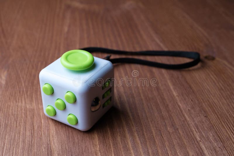 Fidget Cube with Green Buttons on a Wooden Table Stock Photo - Image of ...