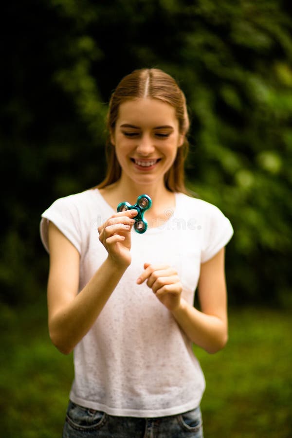 Fidget Spinner in Hands of Young Pretty Girl. Stock Image - Image of ...