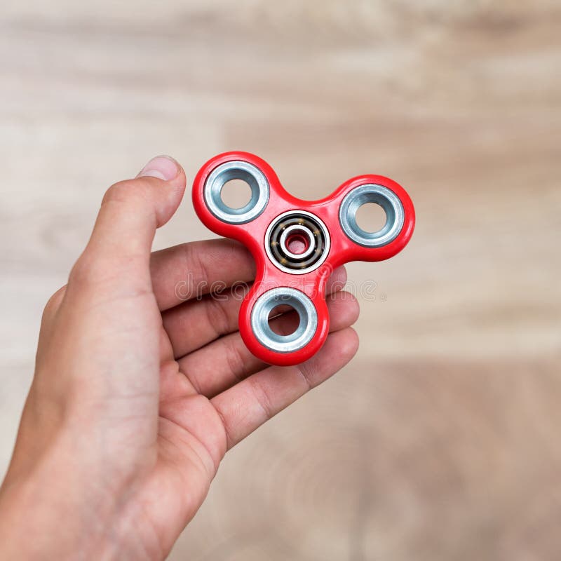 Fidget Spinner. Red Hand Spinner, Fidgeting Hand Toy Rotating on Child ... Fidget Spinner. Red Hand Spinner, Fidgeting Hand Toy Rotating on Child ...