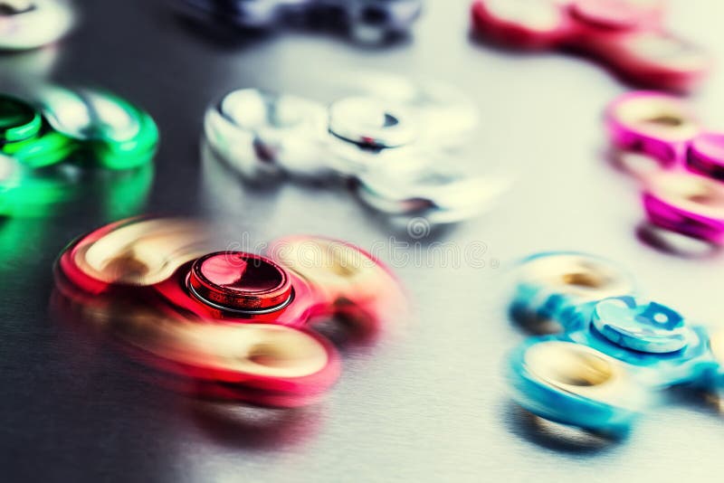 Fidget Spinner. Several Colorful Fidget Spinners on a Stainless Steel ...