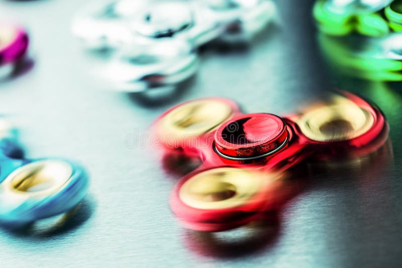 Fidget Spinner. Cute Young Girl Playing with Fidget Spinner Stock Photo ...
