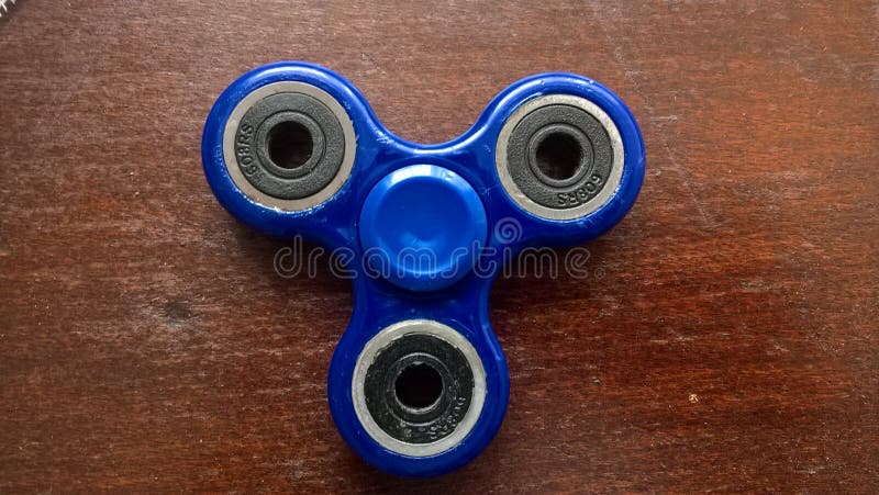 Fidget Spinner on a table stock image. Image of stress - 96323039