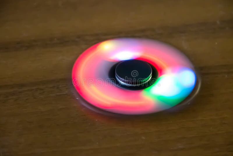Fidget Spinner Toy with Led Light on Table Stock Photo - Image of glow ...