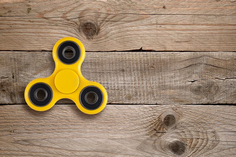Fidget Spinner on a table stock image. Image of stress - 96323039