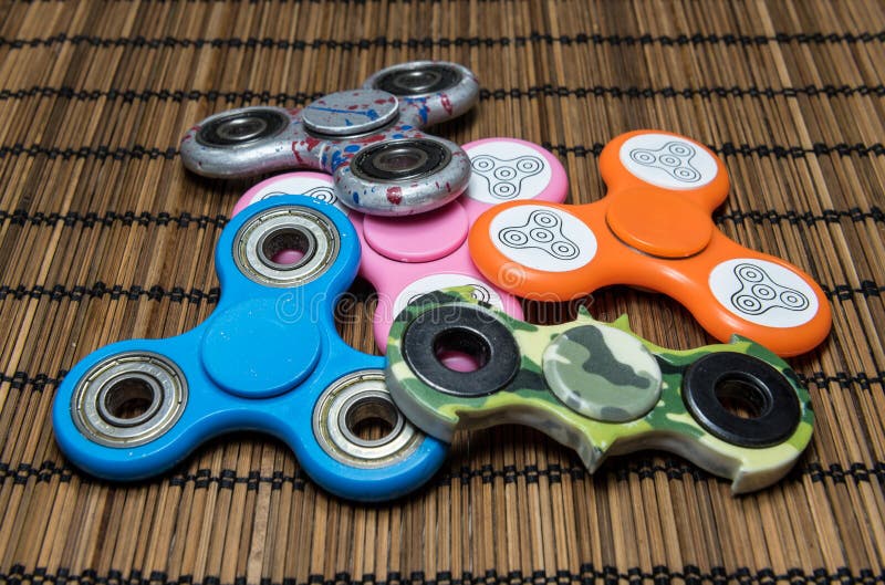 Fidget Spinners on Bamboo Mat Stock Image - Image of fidget, bearing ...