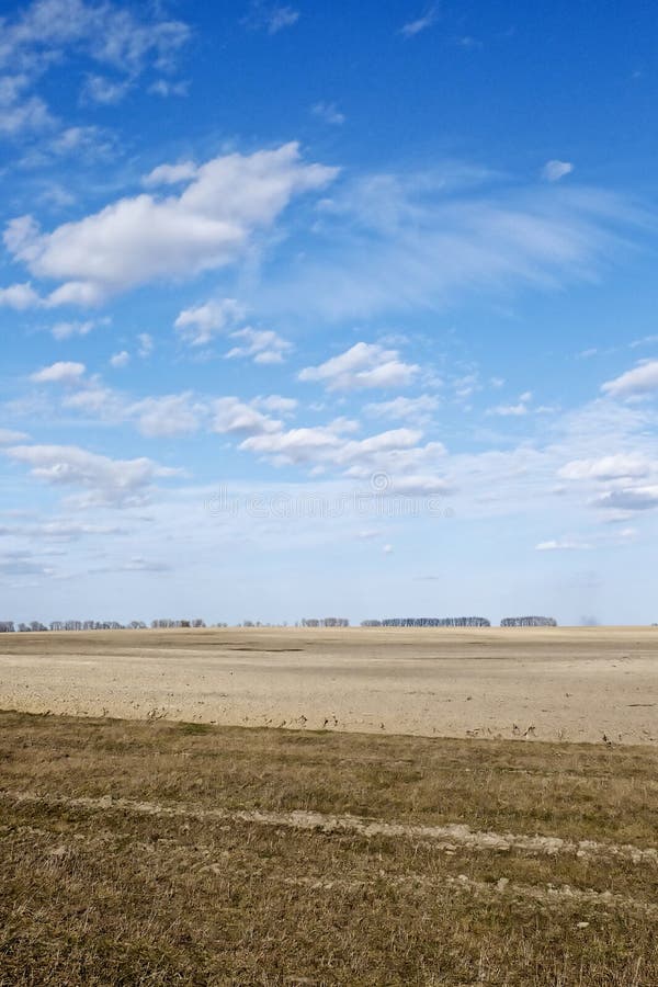 The Field is Desolate and the Sky is a Light Blue Stock Photo - Image ...