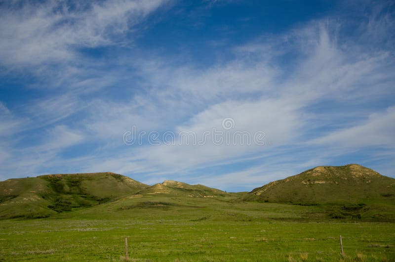 Field and the High Hills Covered in Greens Under the Cloudy Sky Stock ...