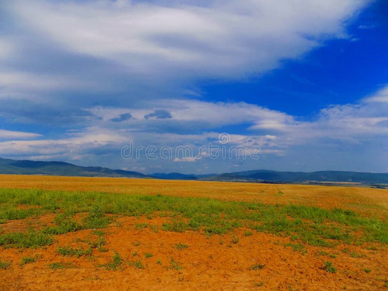 Field, hills and sky stock image. Image of landscape - 64954965