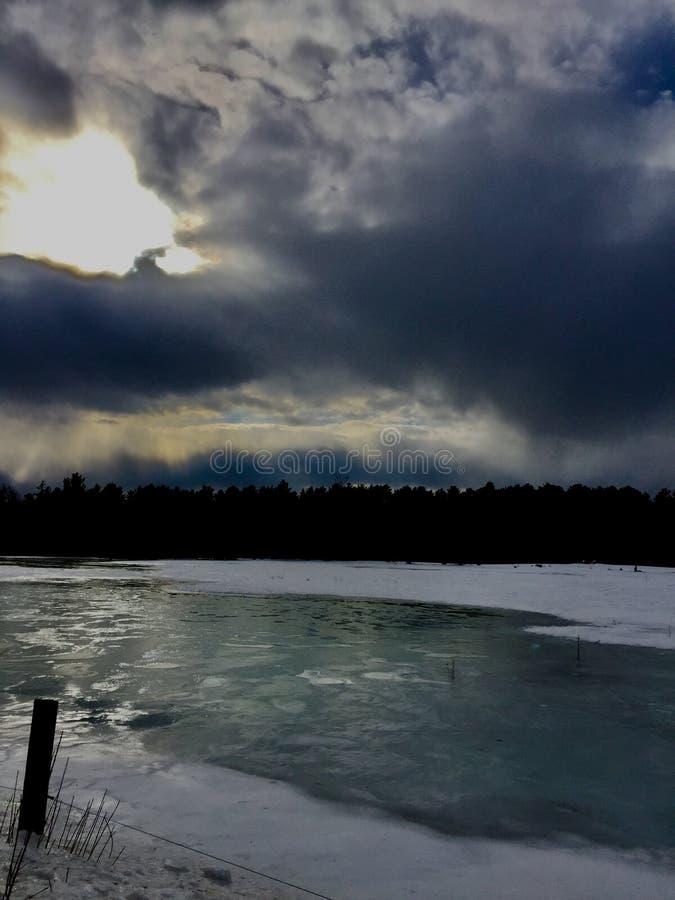 Field with Ice and Snow and Dark Sky Stock Photo - Image of winter ...