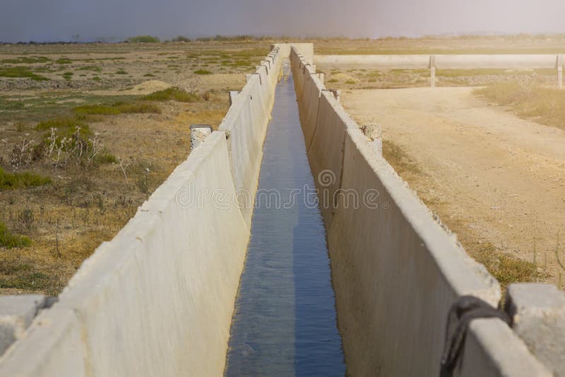Water channel in the field stock photo. Image of beauty - 129291034