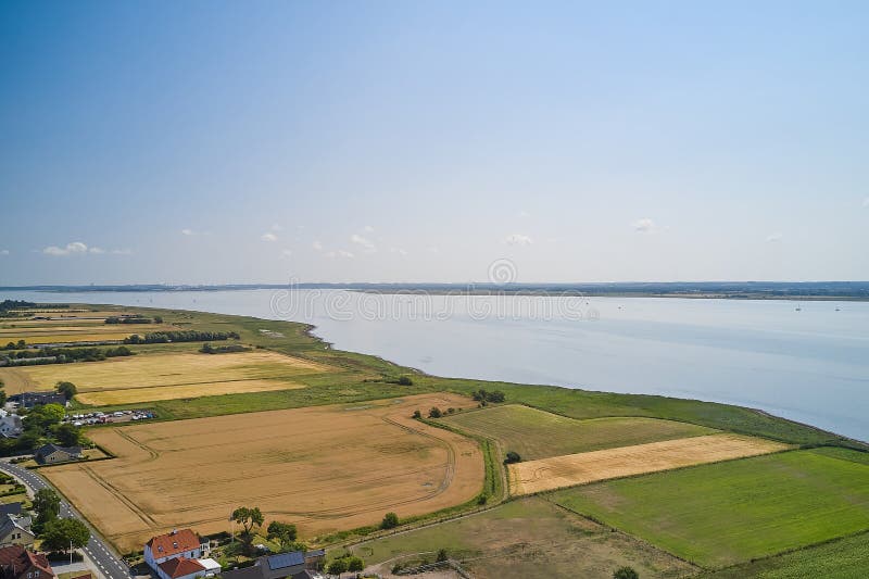 Field and the ocean view stock image. Image of sunset - 257584145