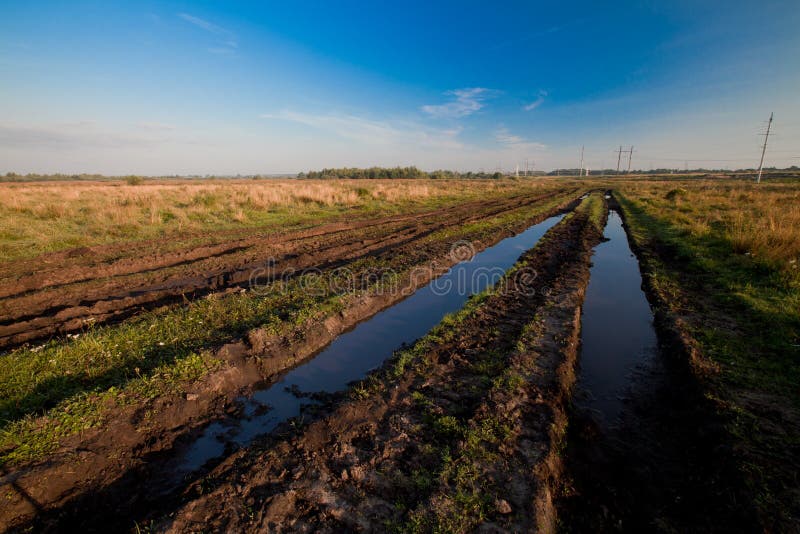 Field with a Road Rut Full of Water Stock Image - Image of field ...