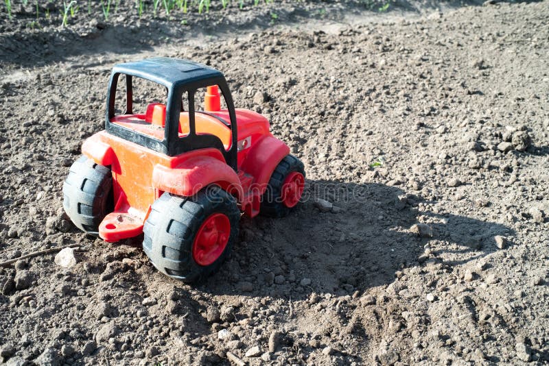 On the Field from the Soil is a Red Tractor Stock Image - Image of ...