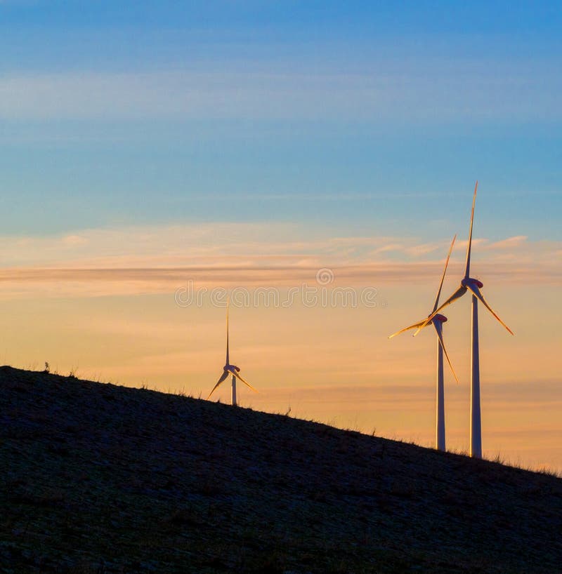 On the Field Stand Three Wind Turbines in the Sunset Stock Photo ...