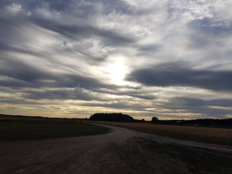 Field sunlit stock image. Image of nature, clouds, field - 142777247