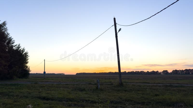 A Field with Two Power Lines and a Pole in the Middle Stock Image ...