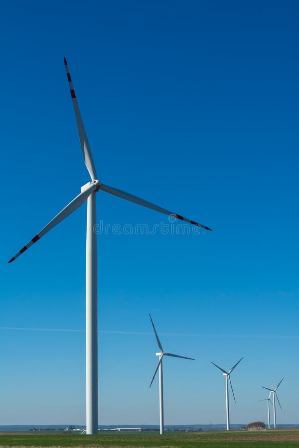 Field with Windmills for Electric Power. Clean Energy Produced by the ...
