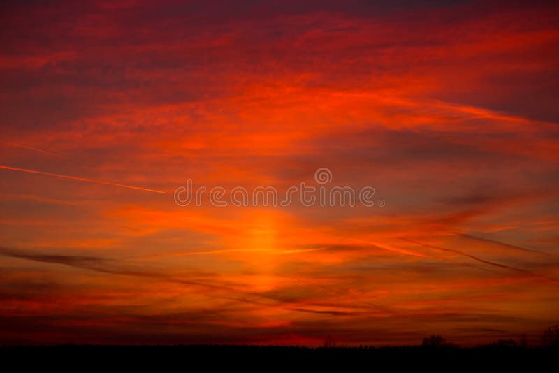 Fiery Red Sunset with the Effect of a Solar Pillar in the Sky Stock ...