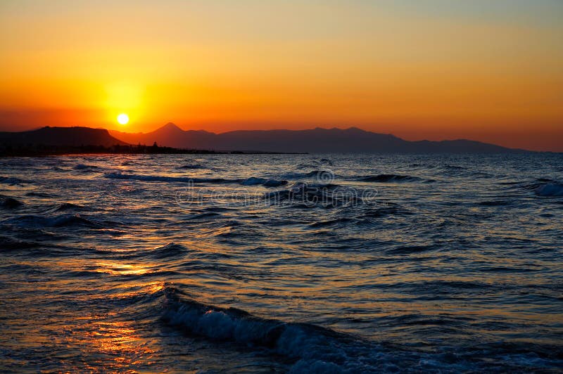 Fiery Red Sunset Over a Turbulent Sea Stock Photo - Image of light ...