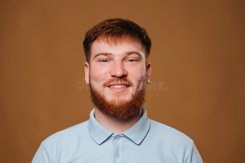 A Fiery Redhead Teen Guy Poses in the Studio, His Intense Gaze Fixed on ...