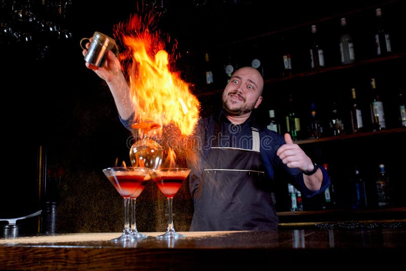 Fiery Show at the Bar. the Bartender Makes Hot Alcoholic Cocktail and ...