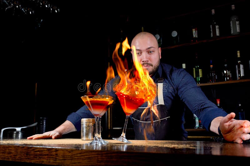 Fiery Show at the Bar. the Bartender Makes Hot Alcoholic Cocktail and ...