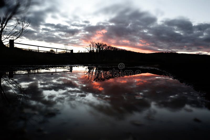 Fiery Sunset Reflection & Flooding after Storm Imogen Stock Image ...