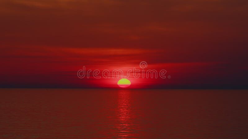 Fiery Sunsets Over Ocean. Bright Sunset with Sun Over Calm Sea Surface ...