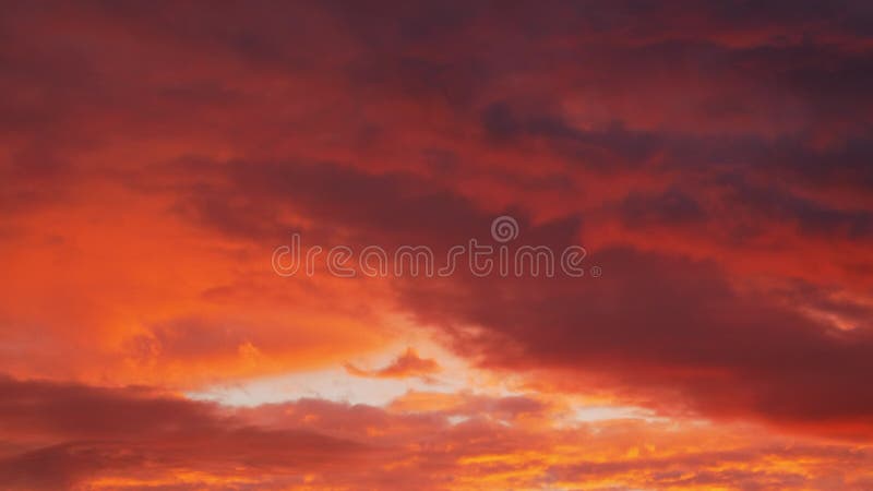 A Fiery Tableau of Deep Red and Orange Clouds Fills the Sky, Creating ...