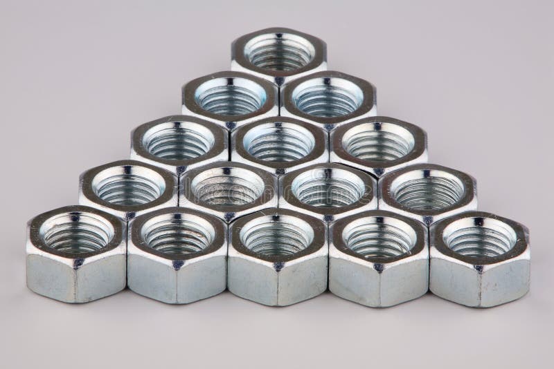 Triangle from metal nuts stock photo. Image of circle - 100279276