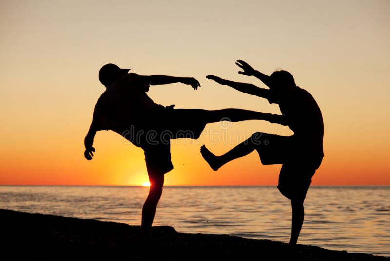 Fight on a beach stock photo. Image of sunset, shadow - 20535696