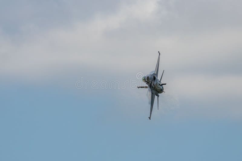 Two Blue Fighter Jets Flying In Tandem In The Sky Releasing White