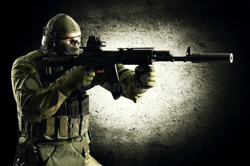 Fighter of a Special Unit is Aiming at the Sight of the Machine Gun ...