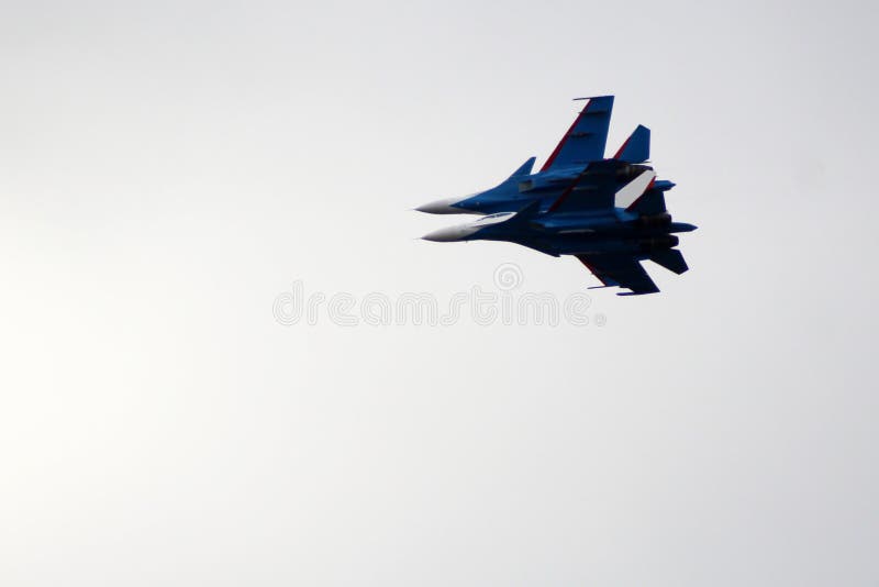 Modern Jet Fighter is Firing a Set of Flares on the Blue Sky. Cloud ...