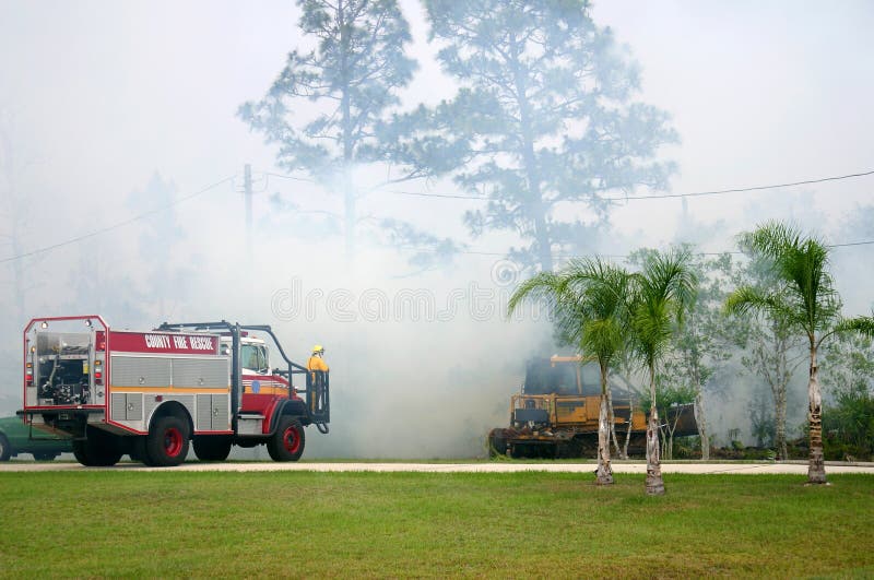 Fighting Fire with Machines Stock Photo - Image of smokey, water: 5656168