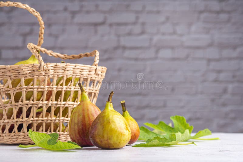 Figs Fruit and Leaves are Placed on a Cement Floor with a Bamboo Basket ...