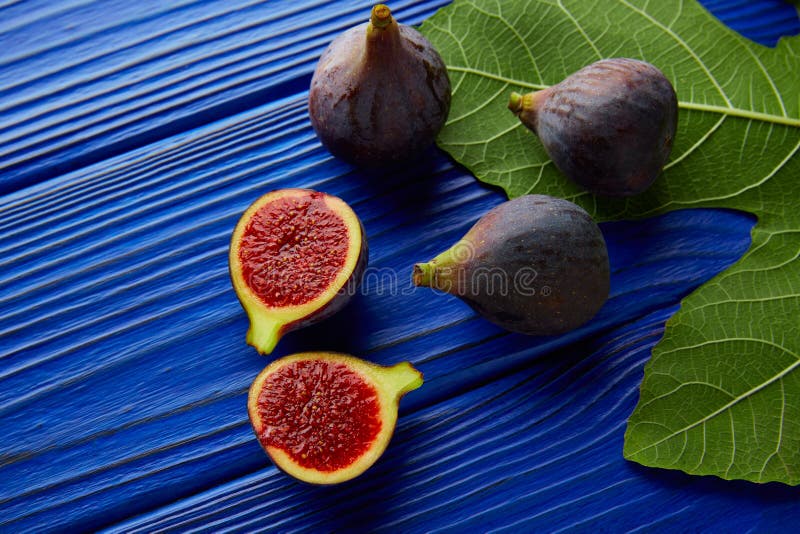 Figs Raw Cutted Fruits and Fig Tree Leaves on Blue Stock Photo - Image ...