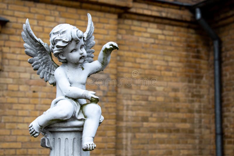 Figure of an Angel on the Background of a Brick Building Stock Photo ...