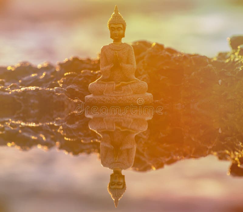 Figure of a Buddha Meditating by the Sea at Sunrise Stock Photo - Image ...