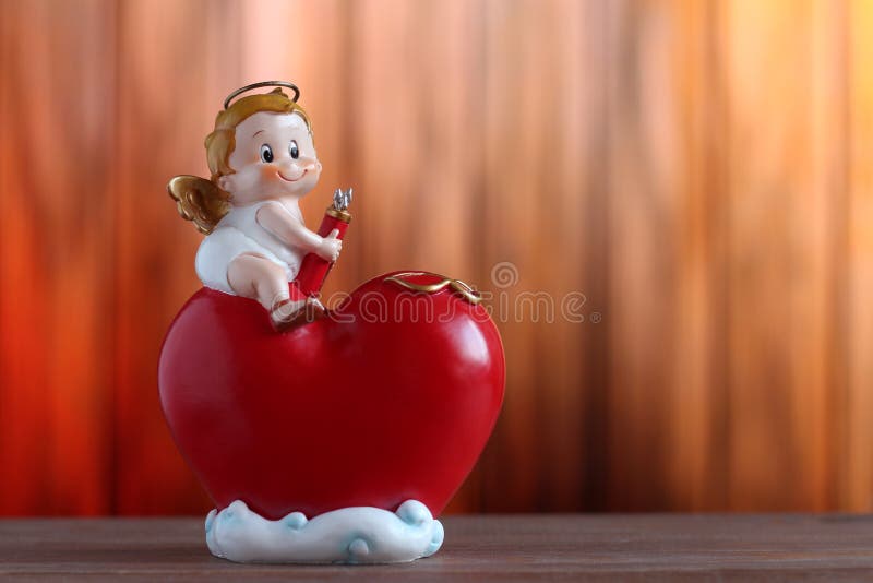 Figure of the Cupid on Big Red Heart Stock Photo - Image of valentine ...