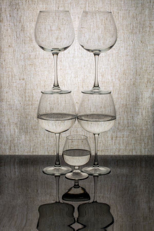 A Figure from Different Glasses with Liquid with Reflection Stock Photo ...