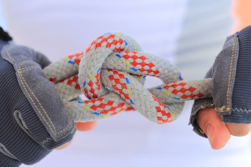 Figure Eight Knot in hands stock photo. Image of object - 155856528