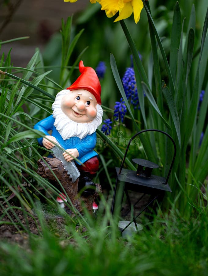 Figure of a Gnome Working in the Garden Stock Photo - Image of green ...