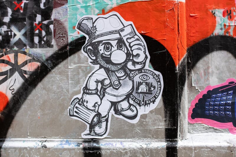 Sticker Art Featuring a Cartoonish Character on a Graffitied Wall ...