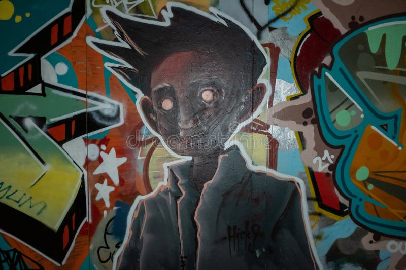 Graffiti Art on a Wall Featuring a Stylized, Shadowy Character with ...