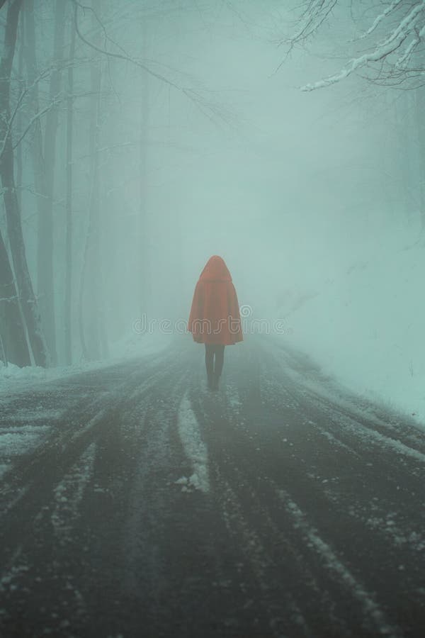 Figure with Red Cloak on a Misty Winter Road Stock Image - Image of ...